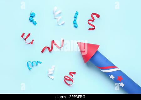 Firework rocket and serpentine for Independence Day on blue background ...