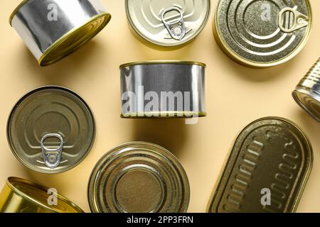 Tin cans with fish on beige background Stock Photo - Alamy
