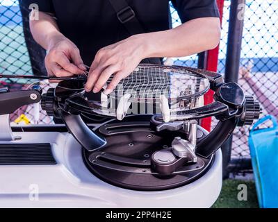 weaving, Stringing badminton racket on racquet weaving machine Stock ...