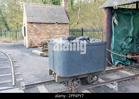 factory coal tub or trolley on tracks filled with coal Stock Photo - Alamy