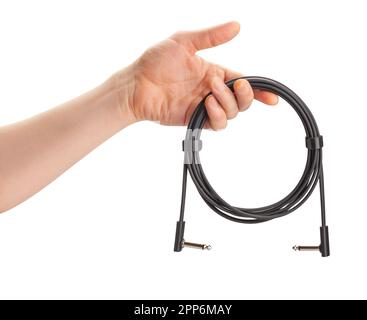 Hand holding a jack instrument cable isolated on a white background ...