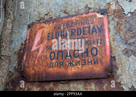Old and rusty soviet-era warning sign of high voltage electricity on a ...