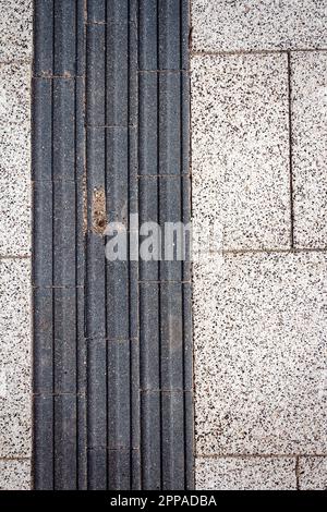 Textured walkway for blind people. Black tactile paving for the ...