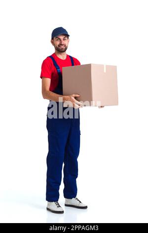 Hard worker courier man holding big box long view Stock Photo - Alamy