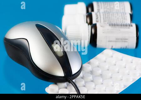 Mouse and pills as symbol for online ordering of medicine in an ...