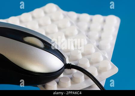 Mouse and pills as symbol for online ordering of medicine in an ...