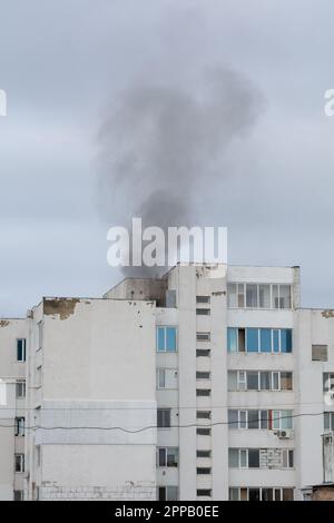 Burning roof of a residential high-rise building, clouds of smoke from ...