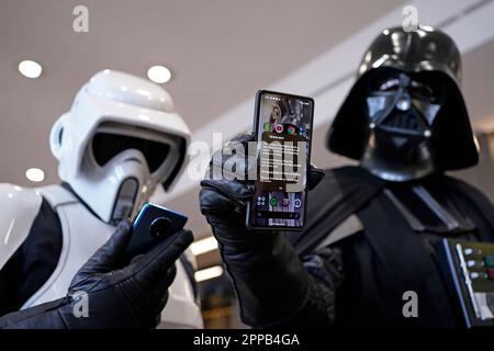 A cosplayer dressed as Darth Vader with his mobile phone during a test ...