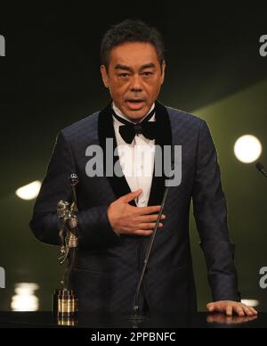 Hong Kong actor Lau Ching-wan (or Sean Andy) poses with his award for ...