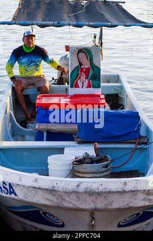 Mexican fisherman with a Virgin de Guadelupe icon on his boat. Yucatan ...