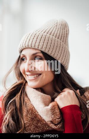Happy woman wearing knit hat lying on jetty Stock Photo - Alamy