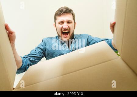 young man screaming inside a cardboard box Stock Photo - Alamy