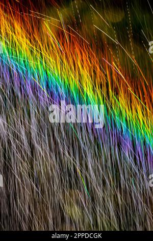 Long exposure of spray of water covered in rainbow colored light Stock ...