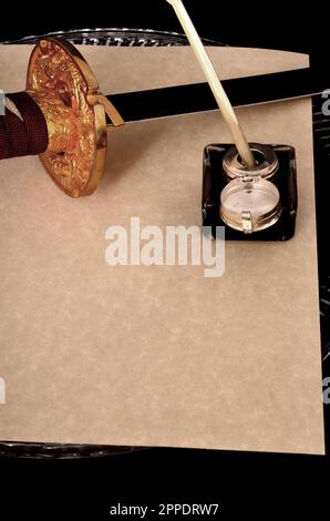 Quill parchment sword and ink well isolated over black Stock Photo - Alamy
