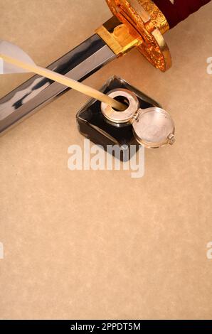 Quill parchment sword and ink well isolated over black Stock Photo - Alamy