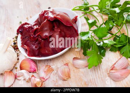 Raw rabbit liver ready for cooking on cutting board Stock Photo - Alamy