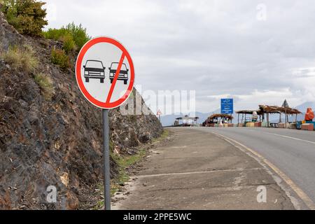 Sign - overtaking is prohibited on the side of a beautiful mountain ...