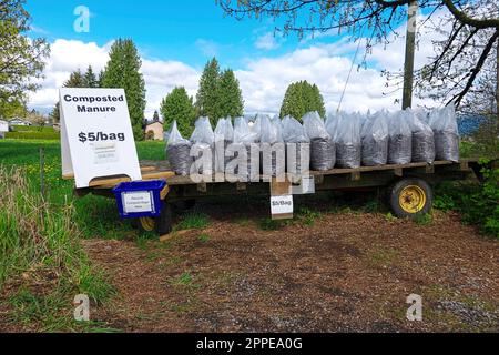 Composted steer manure bagged in plastic bags and for sale on a flatbed ...