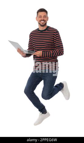 Happy man with laptop jumping on purple background Stock Photo - Alamy