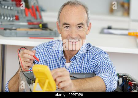 a man is fixing a voltage problem Stock Photo - Alamy