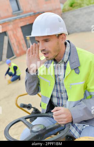 Construction worker yelling at colleague Stock Photo - Alamy