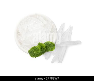 Translucent menthol crystals and green mint leaves falling on white ...