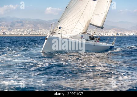 Sailing in the wind through the waves at the Aegean Sea in Greece ...