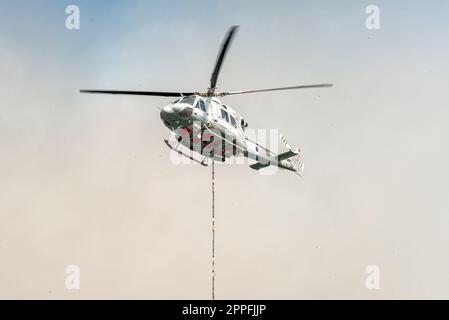 extinguisher fighting fire close up. blue background Stock Photo - Alamy