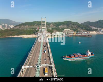 An aerial view of Tsing Ma Bridge in Hong Kong surrounded by the water ...