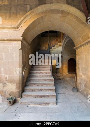 Staircase with wooden balustrade leading to an old abandoned historic ...