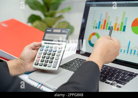 Asian accountant working and analyzing financial reports project ...