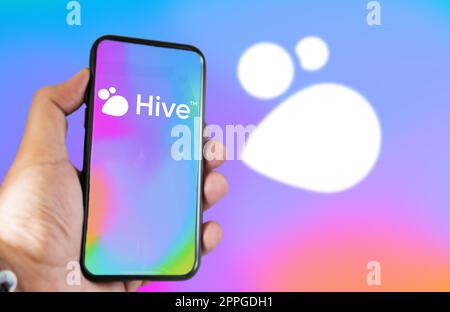 hand holding a phone with Hive Social mobile app on screen Stock Photo ...