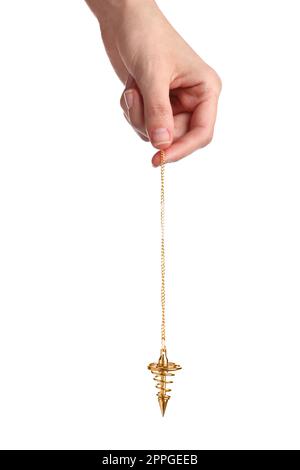 Woman holding golden pendulum with chain on white background, closeup ...