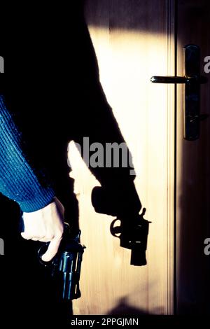 Male hand holding gun on white background Stock Photo - Alamy