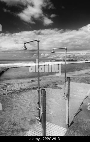 Black and white outdoor beach shower in front of the ocean at Paralia ...