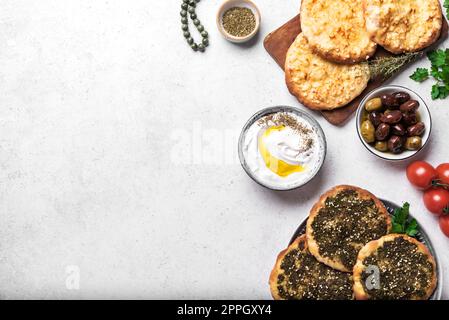 Arabic breakfast, labneh yogurt, manakeesh or pita bread with cheese ...