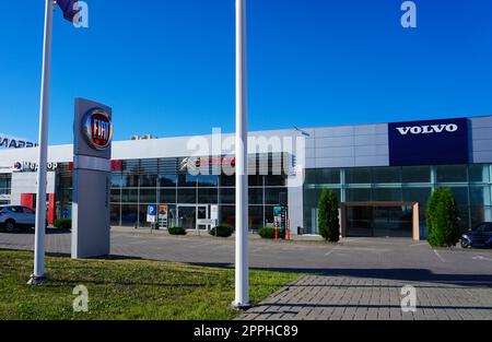 Advertising sign of the car brand VOLVO in front of a sky with clouds ...