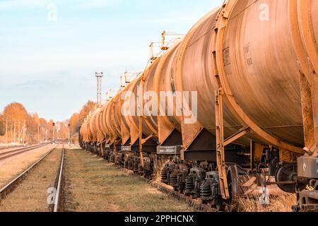 Railroad train of tanker cars transporting crude oil on the tracks ...