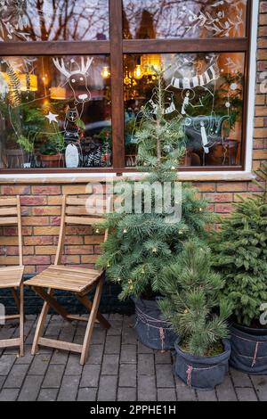 Bench near Christmas cafe bakery at snowy street Stock Photo - Alamy