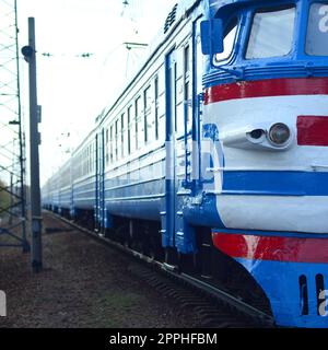 Old soviet electric train with outdated design moving by rail Stock ...