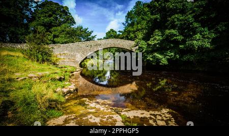 Stainforth packhorse bridge crossing the River Ribble, Yorkshire Dales ...