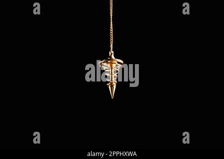 Beautiful golden pendulum with chain on black background, space for ...