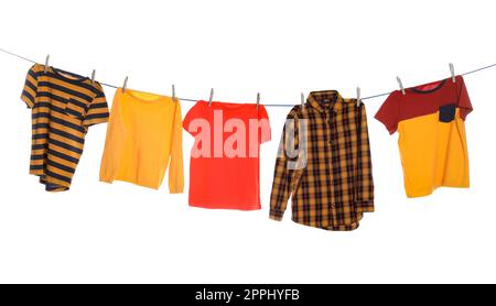 Different bright clothes drying on washing line against white ...