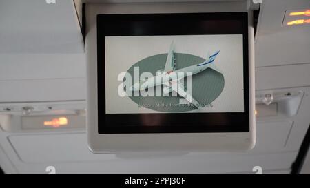 LCD Screen in Airplane with movie explanation. Passenger plane interior ...