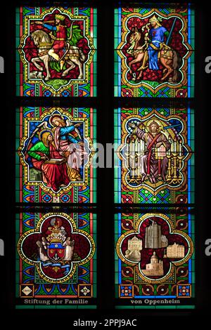 A vertical shot of a stained-glass window in Saint Vitus Cathedral ...