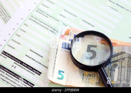 Income tax return form with magnifying glass Stock Photo - Alamy