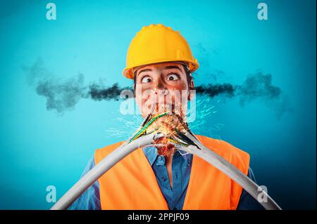 Shocked worker girl with helmet breaks an electric cable Stock Photo ...