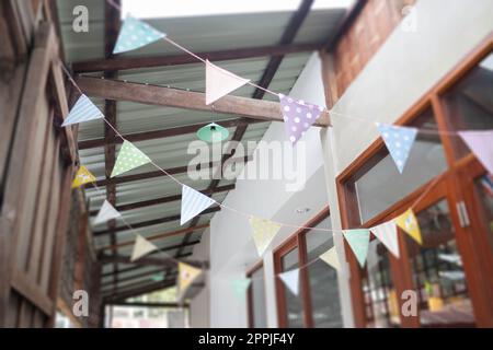 Festive colorful flags decorated on wooden architecture, stock photo ...