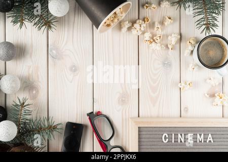 Popcorn, 3D glasses, remote control and film reel on dark background ...