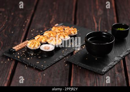 Fresh raw eel with ingredients close-up on a slate board on the table ...